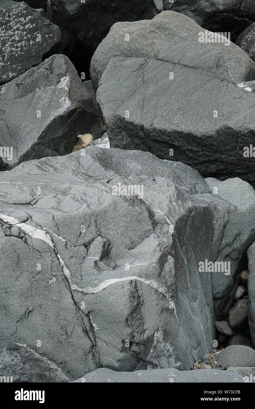 Large boulders forming a sea wall and providing protection from sea ...