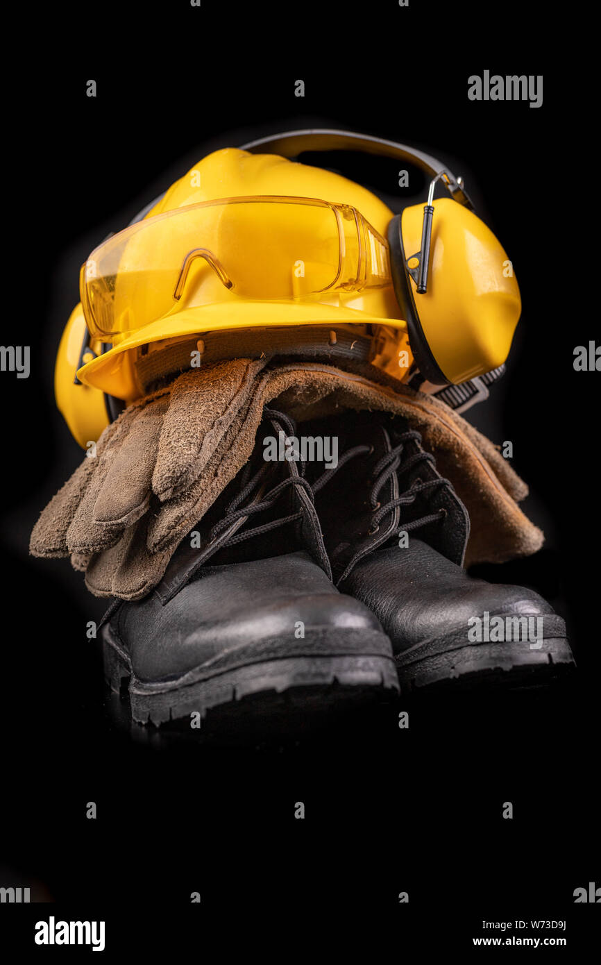 Helmet, gloves and scoop on a dark workbench. Safety and hygiene ...