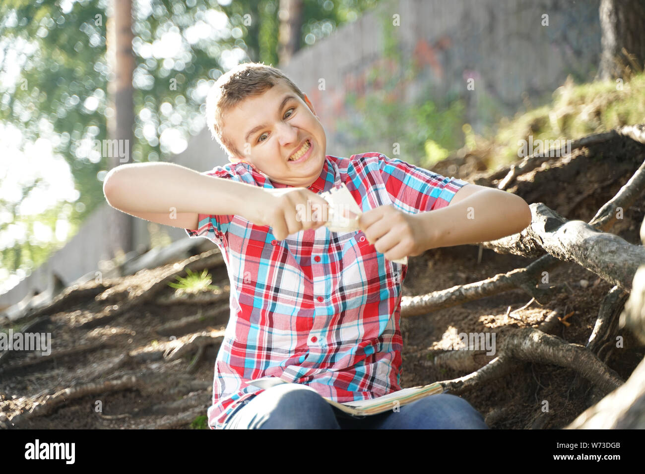 the student gets angry and tears up his notebook with the homework ...