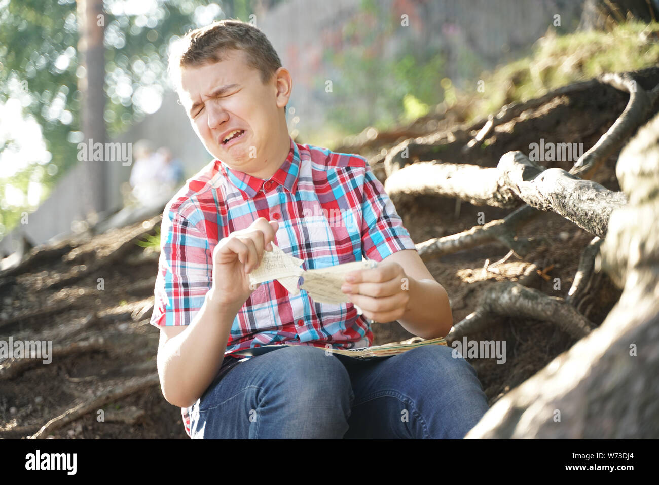 the student gets angry and tears up his notebook with the homework ...