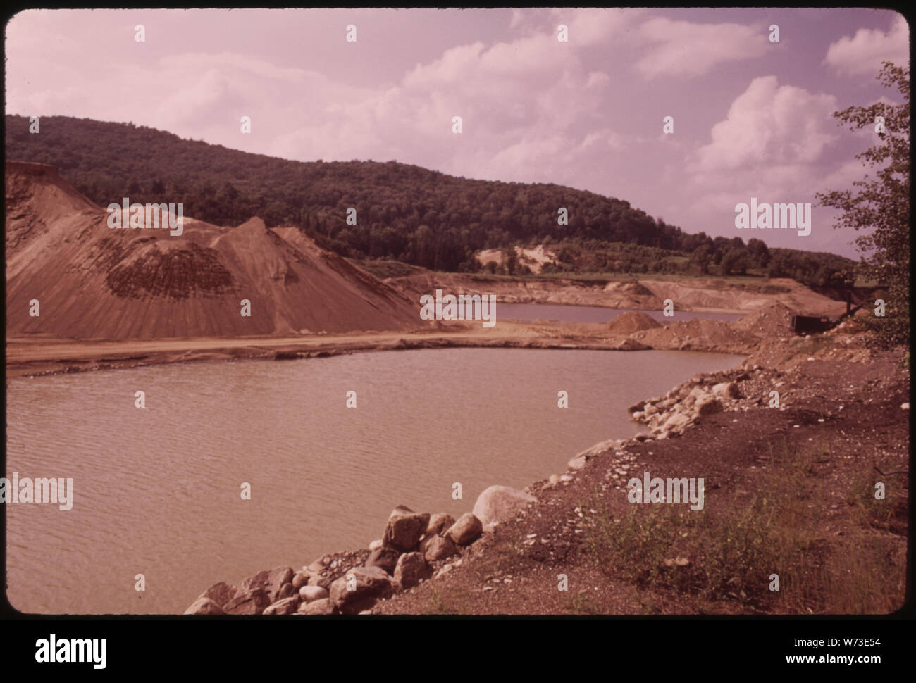 WATER-FILLED PIT IS THE RESULT AFTER A DRAGLINE DREDGED MATERIALS TO BE ...