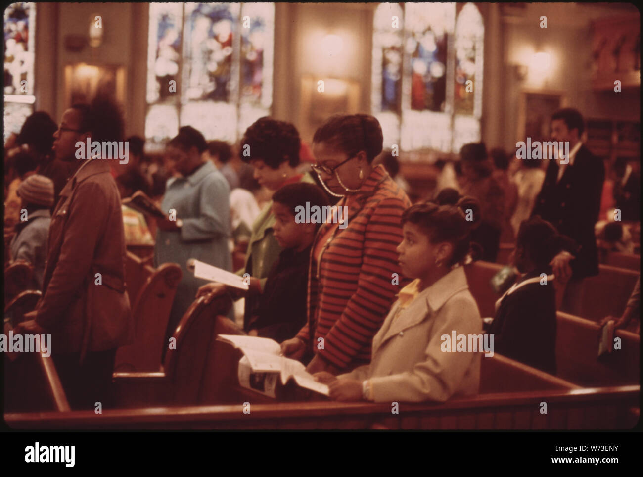WORSHIPPERS AT HOLY ANGEL CATHOLIC CHURCH ON CHICAGO'S SOUTH SIDE. IT ...