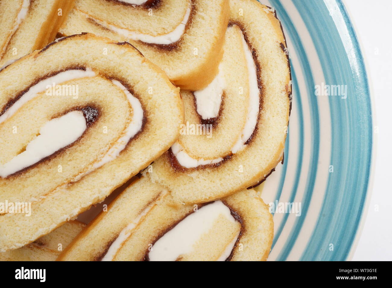 Delicious sweet biscuit roll on a blue plate Stock Photo - Alamy