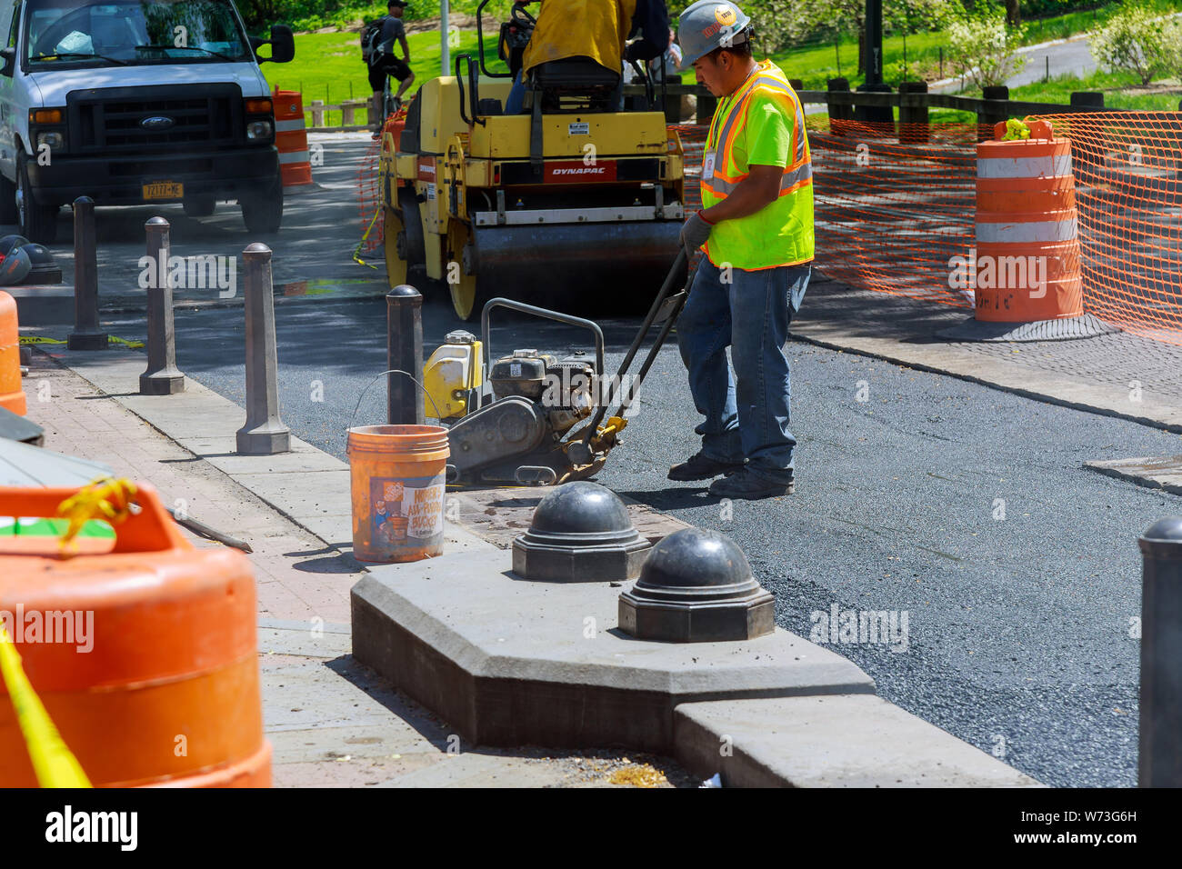 19 JUNE 2019 Road roller machine works on the fresh asphalt bitumen ...
