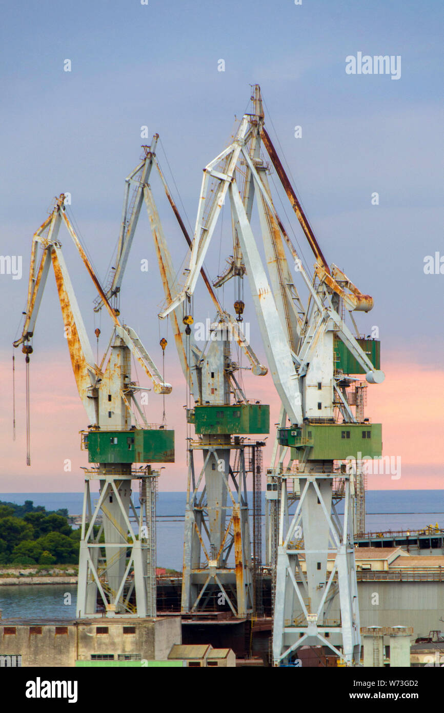 Shipyard at work, ship repair. Industrial machinery, cranes. Transport ...