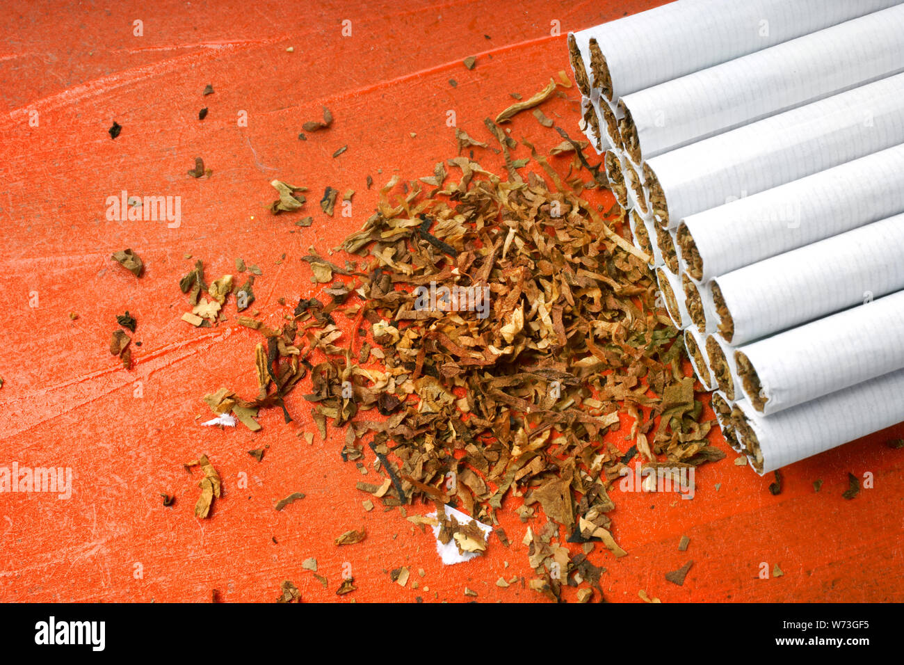 Cigarette on a orange background Stock Photo - Alamy