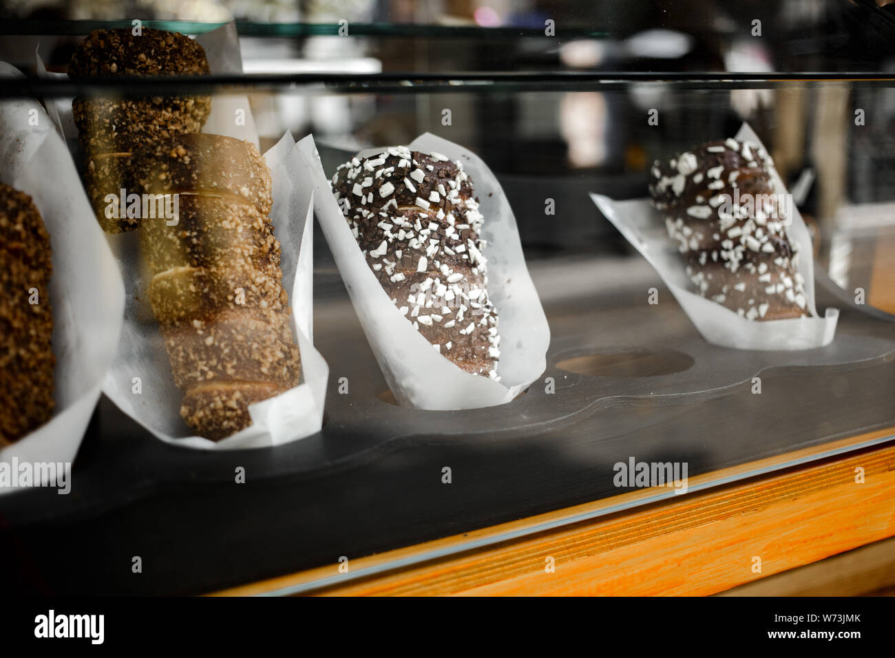 Trdelnik or Trdlo or Kurtosh Kalach being baked on the counter ...