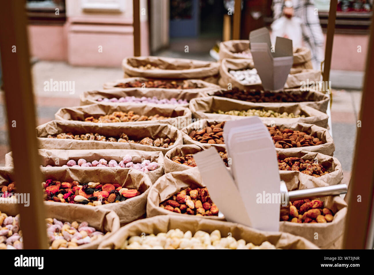 Close up of small bags with nuts. Inside the paper bags are dried ...