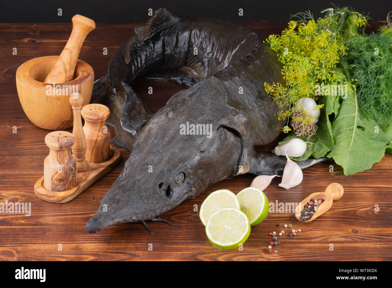 Fresh raw sturgeon fish on the table with lemon pepper garlic. clouse ...