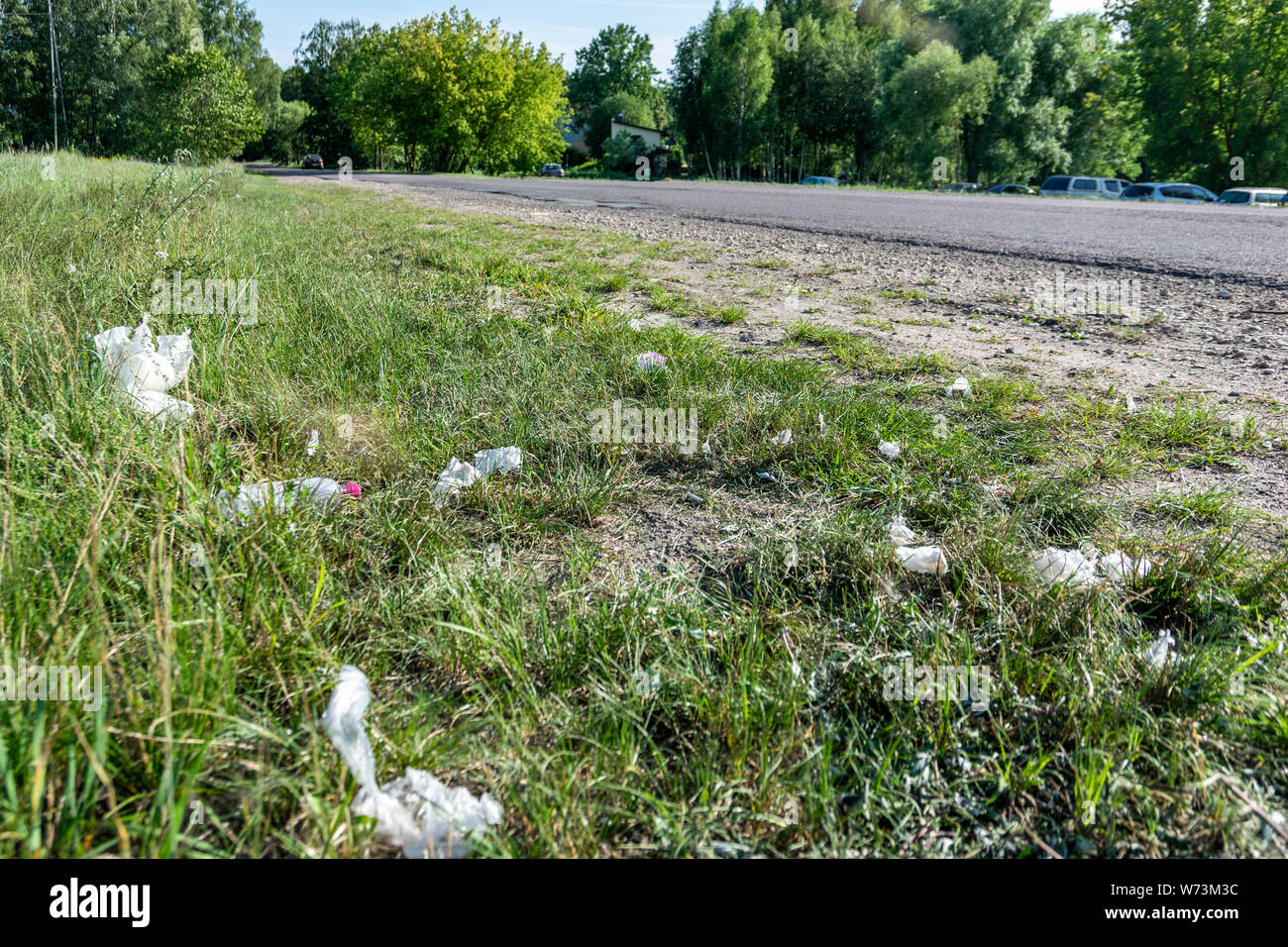 Garbage is scattered on the side of the road Stock Photo - Alamy