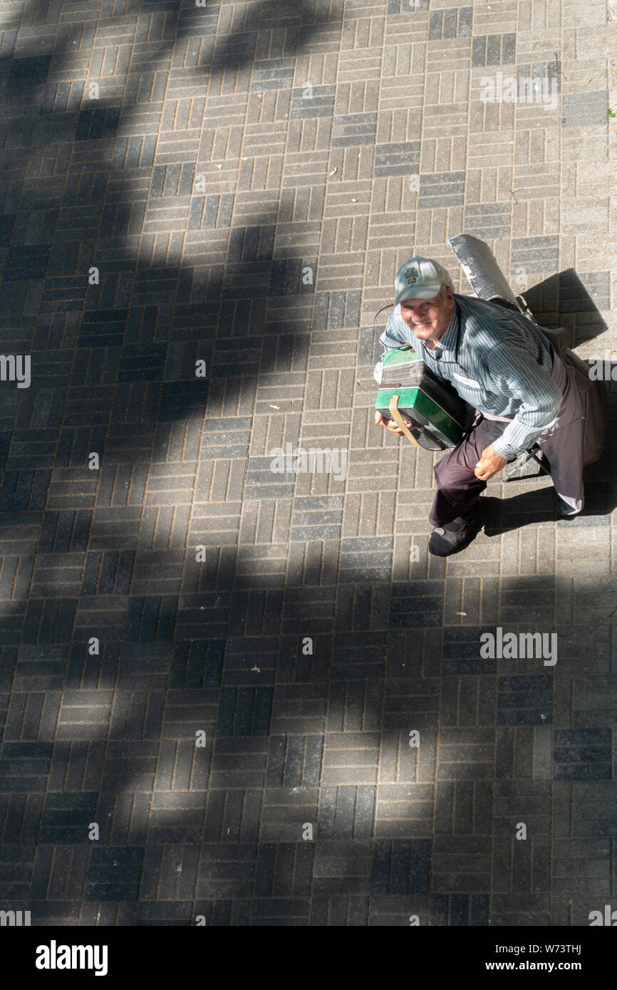 Unusual view looking down on a smiling street musician Stock Photo - Alamy