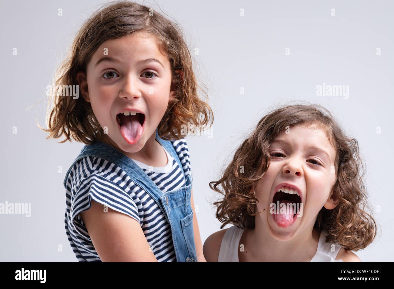 Two girls sticking tongues out hi-res stock photography and images - Alamy