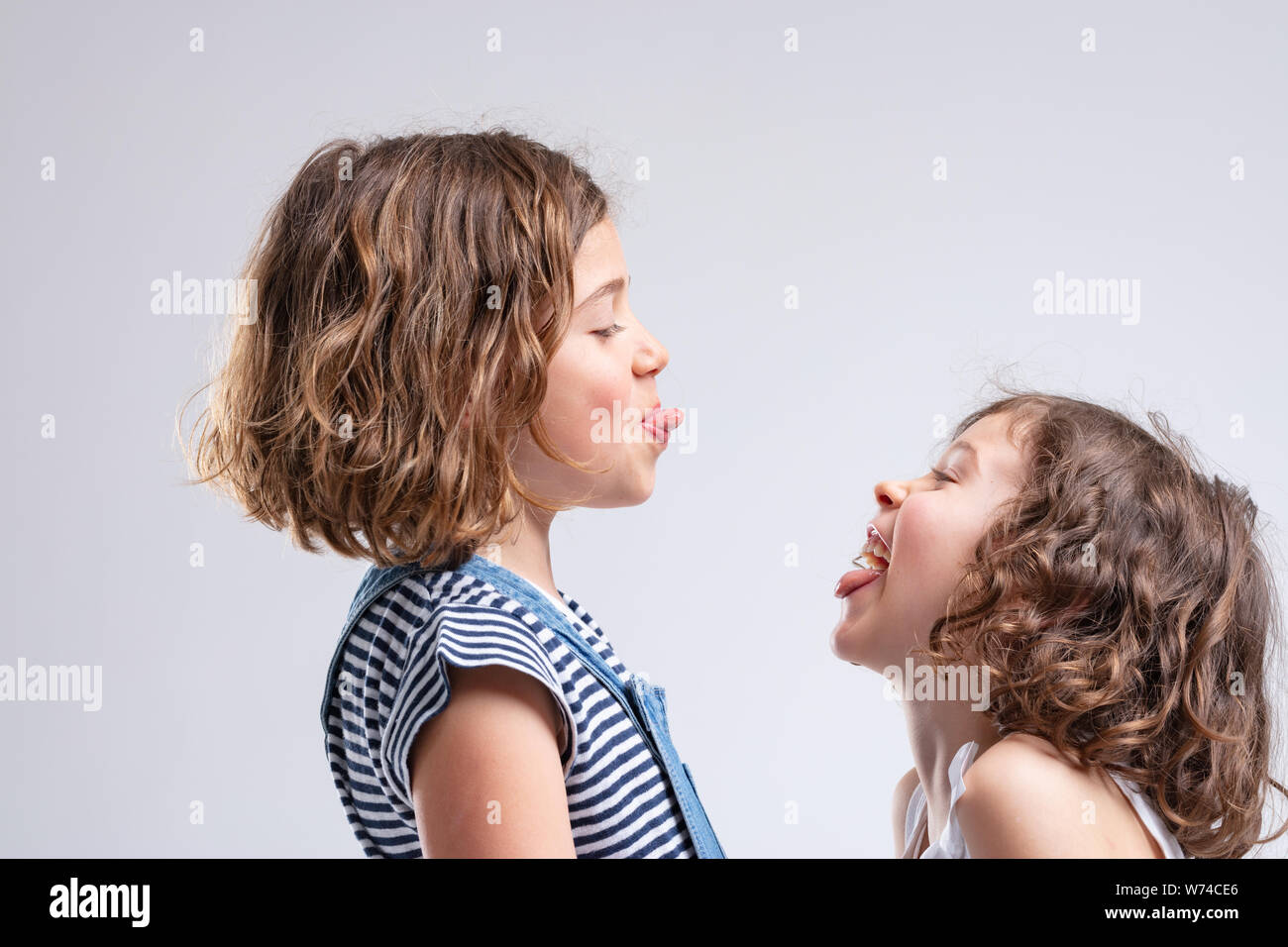 Two girls sticking tongues out hi-res stock photography and images - Alamy