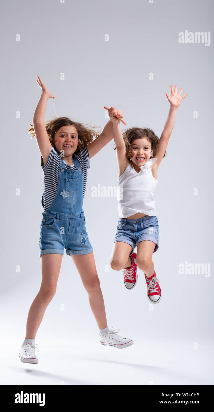 Happy kids arms raised together hi-res stock photography and images - Alamy