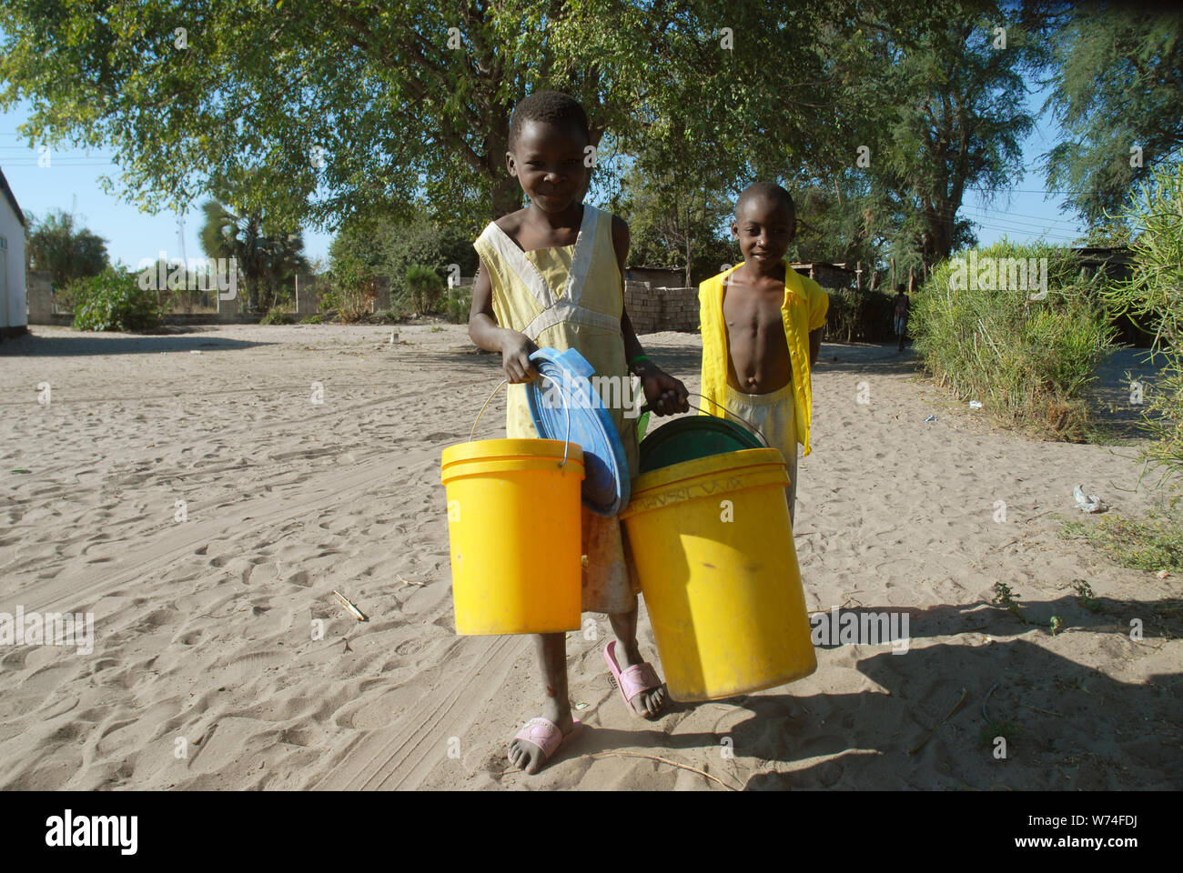 Young village children collecting water, Mwandi, Zambia. Africa Stock ...