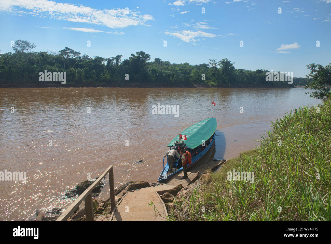 Longtail boat on the Tambopata River, Tambopata National Reserve ...