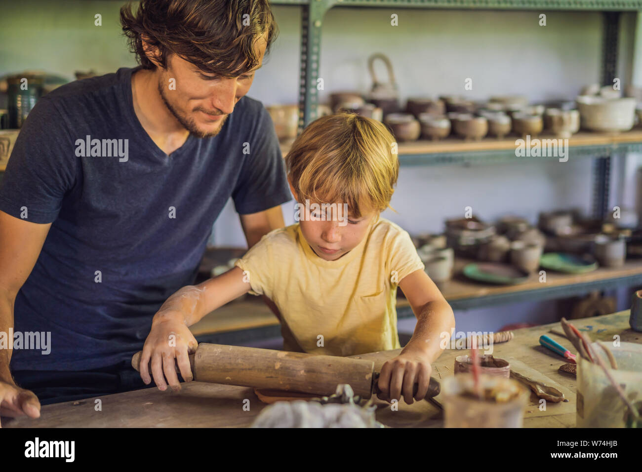Father and son doing ceramic pot in pottery workshop Stock Photo - Alamy