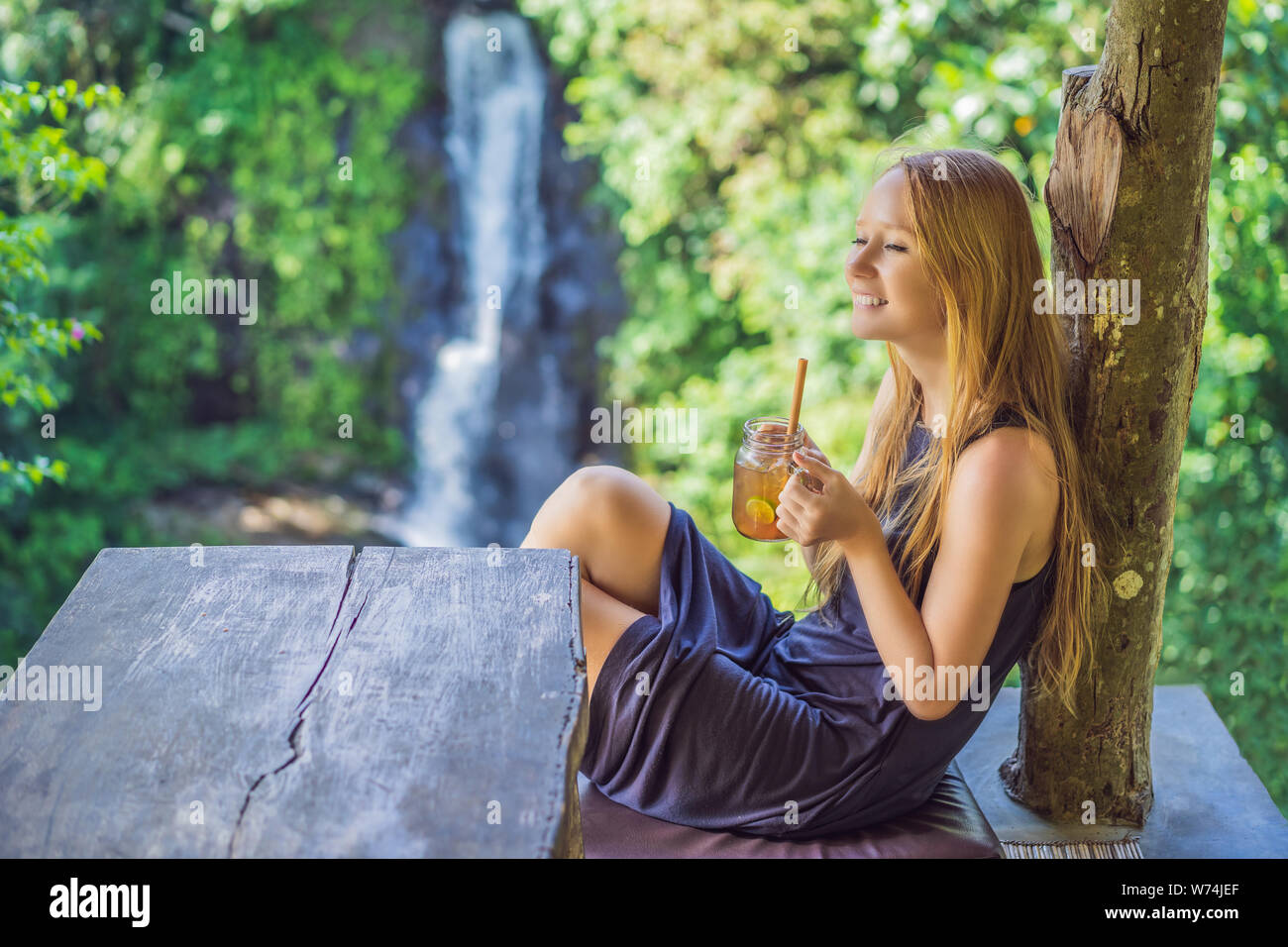 Closeup portrait image of a beautiful woman drinking ice tea with ...