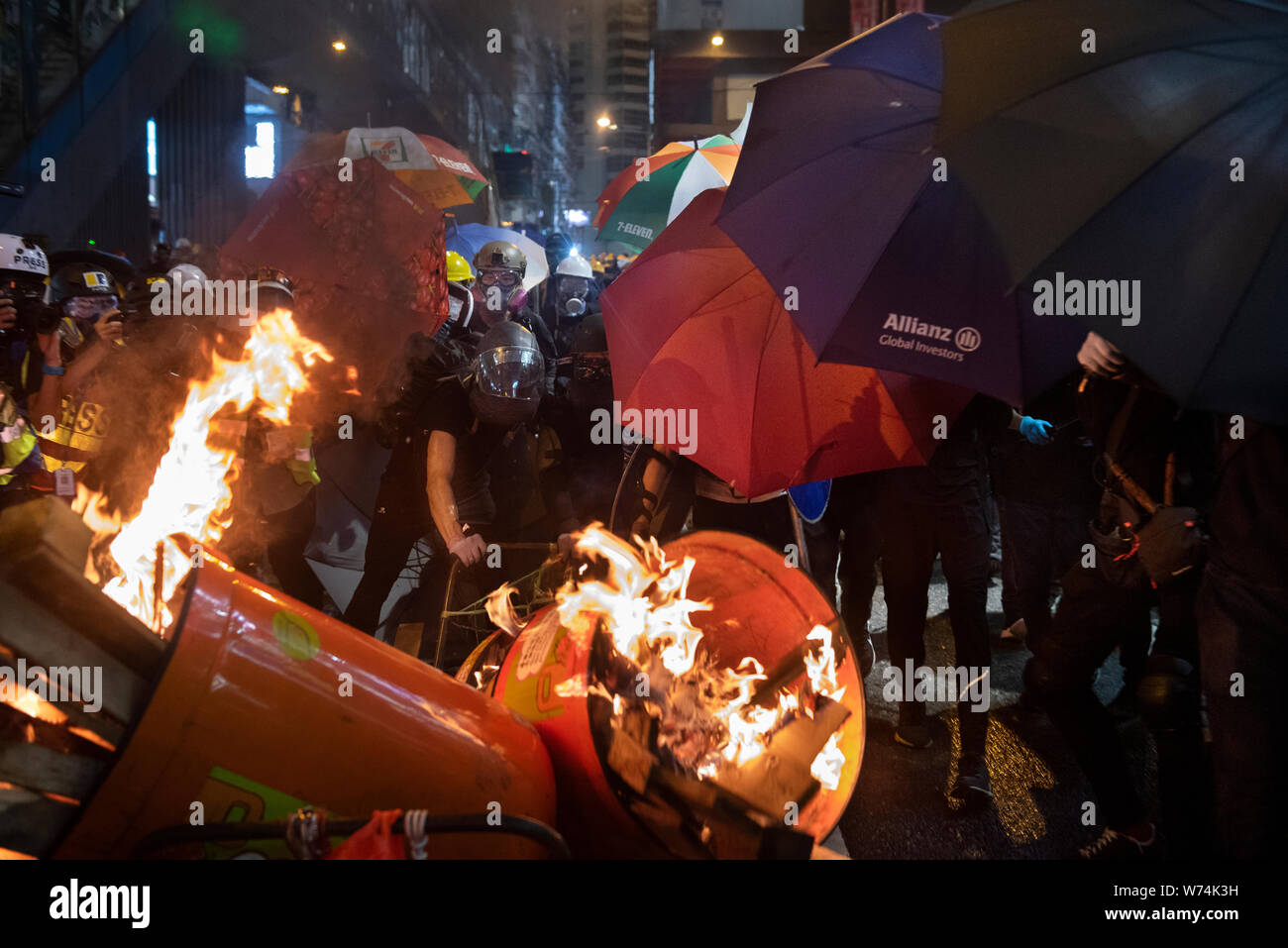 Demonstrators set garbage cans on fire during the confrontation between ...