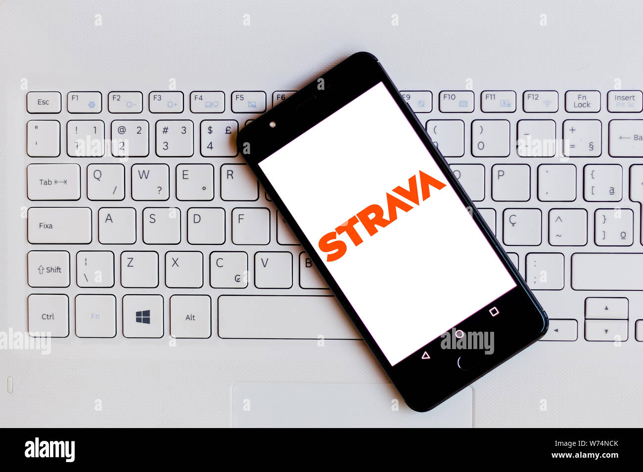 In this photo illustration the Strava logo is seen displayed on a ...