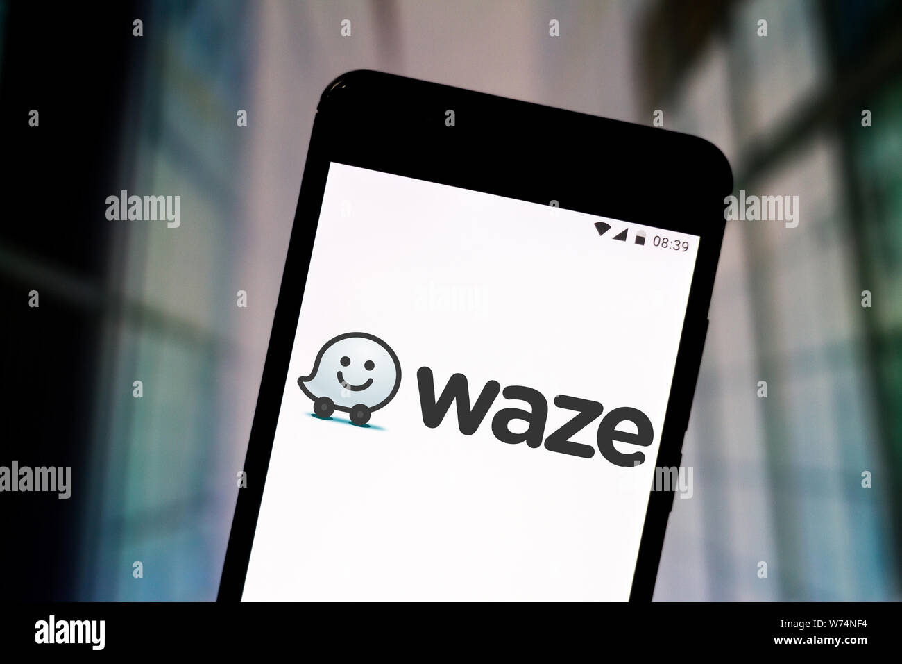 In this photo illustration the Waze logo is seen displayed on a ...