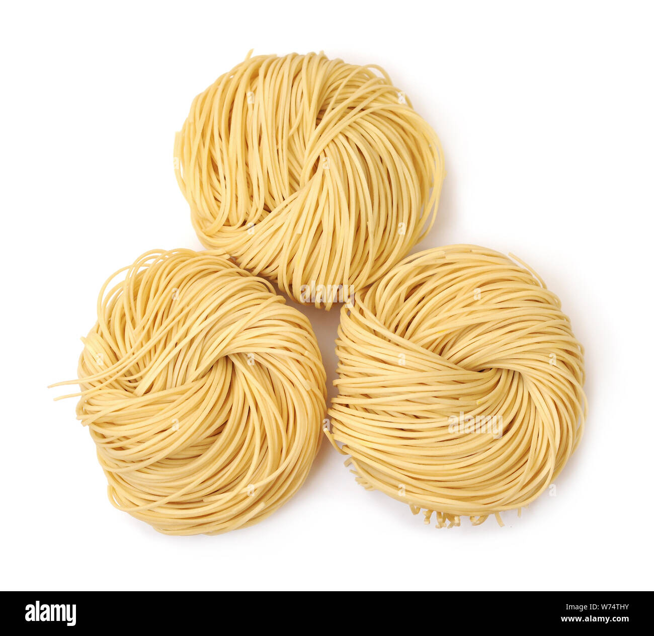 three bunches of dried noodle on white background Stock Photo - Alamy