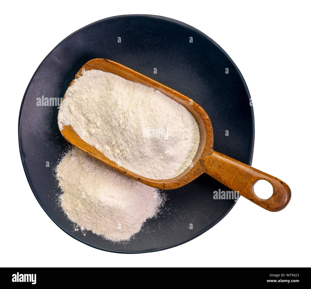 Cassava (yuca) flour on a wooden scoop and plate. It is a gluten free ...