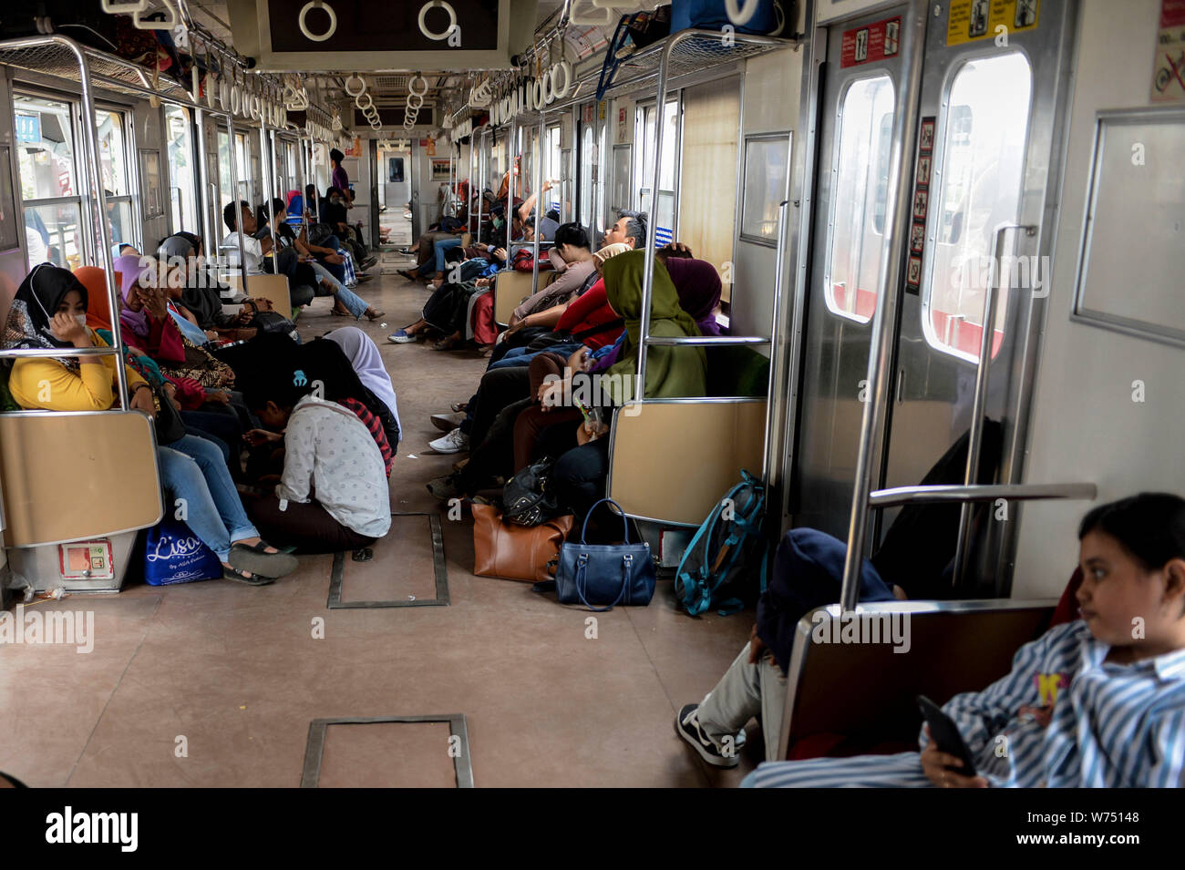 Beijing, Indonesia. 4th Aug, 2019. Passengers wait inside a commuter ...