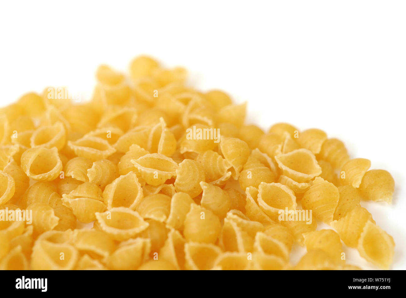shell shape pasta on white background Stock Photo - Alamy