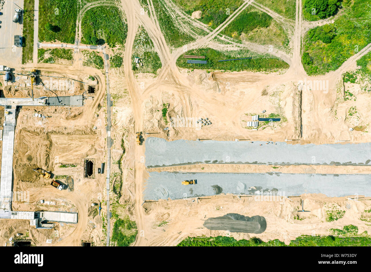 aerial top view of machinery constructing road intersection. industrial ...