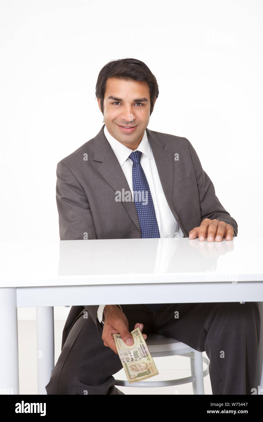 Money under table businessman hi-res stock photography and images - Alamy
