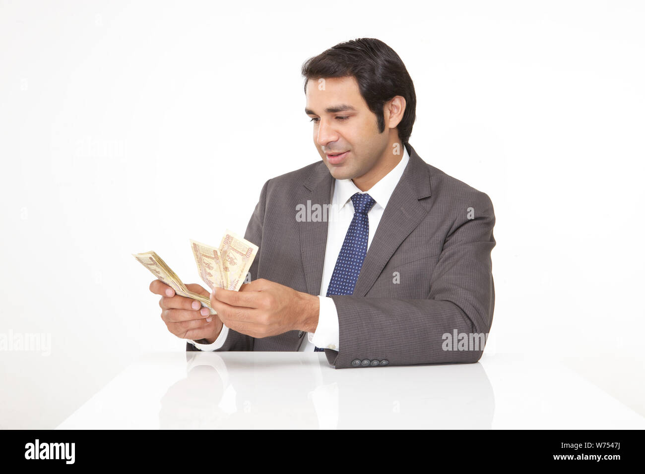 Indian businessman counting money Stock Photo - Alamy