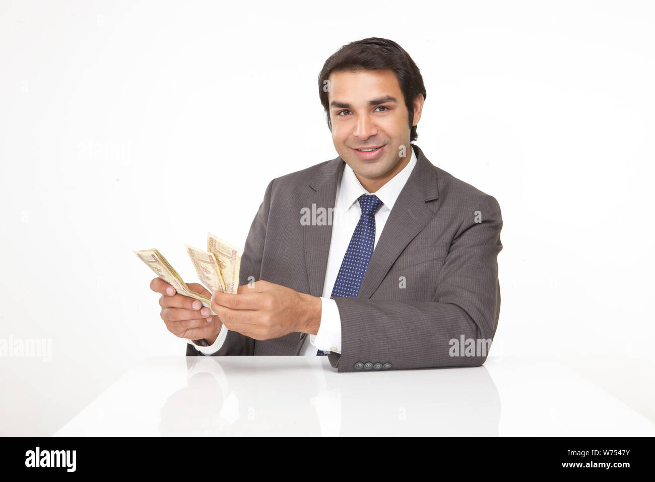 Businessman counting money Stock Photo - Alamy