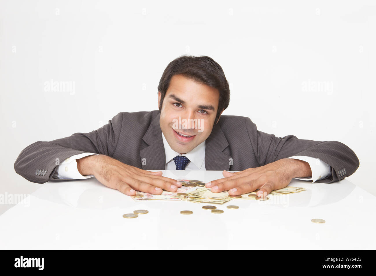 Businessman grabbing money Stock Photo - Alamy