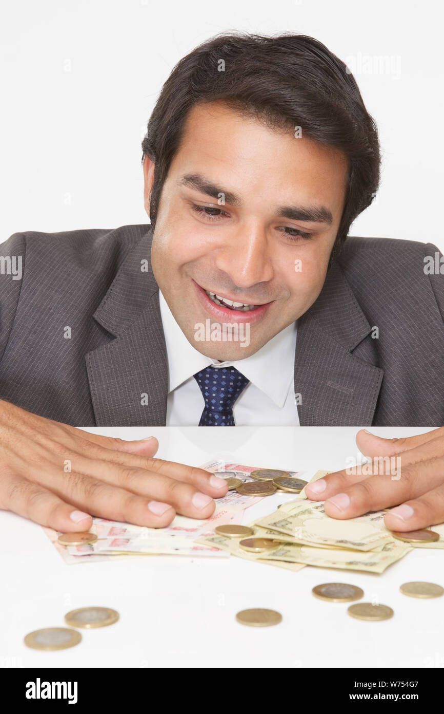 Indian businessman grabbing money Stock Photo - Alamy
