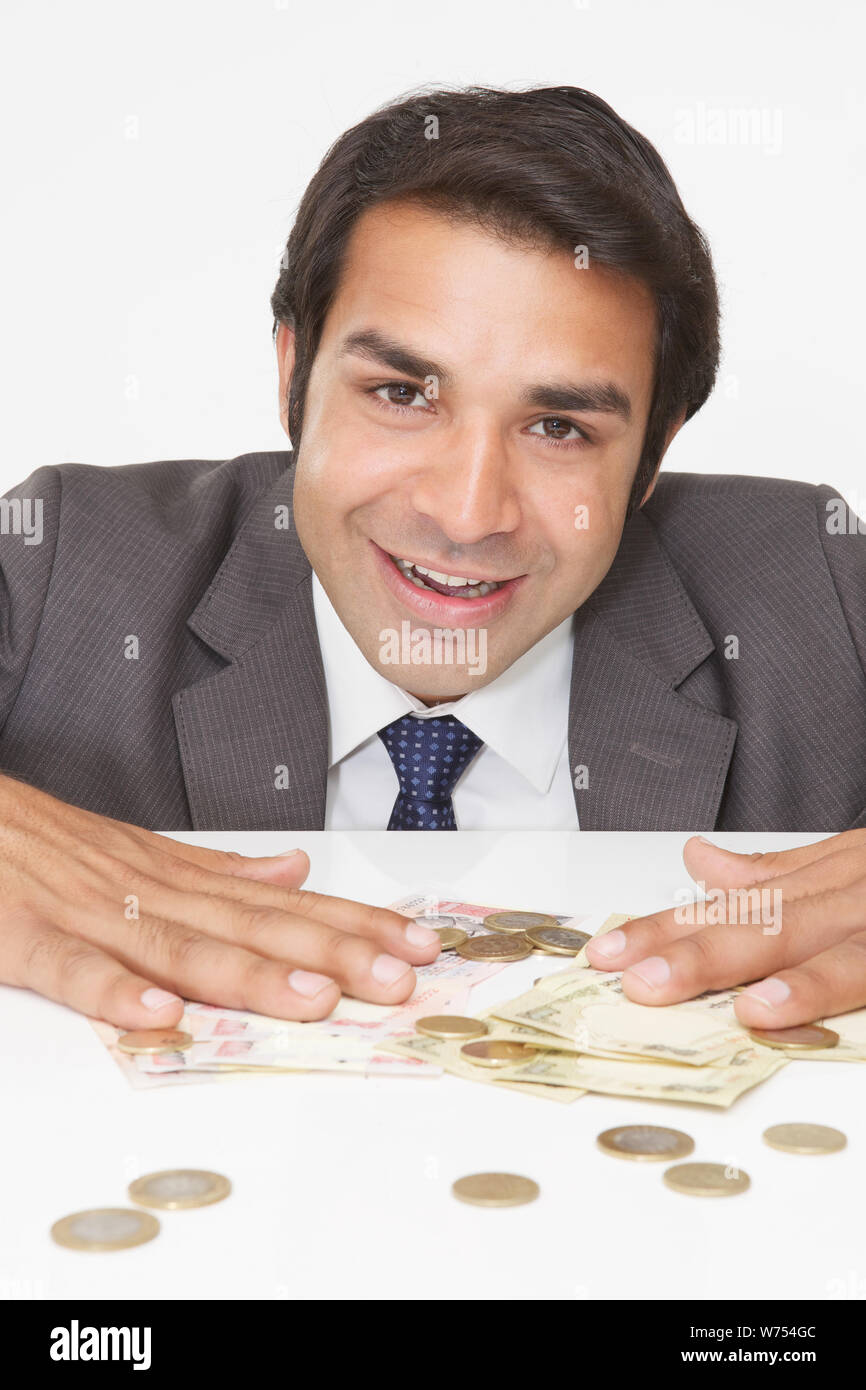 Businessman grabbing money Stock Photo - Alamy