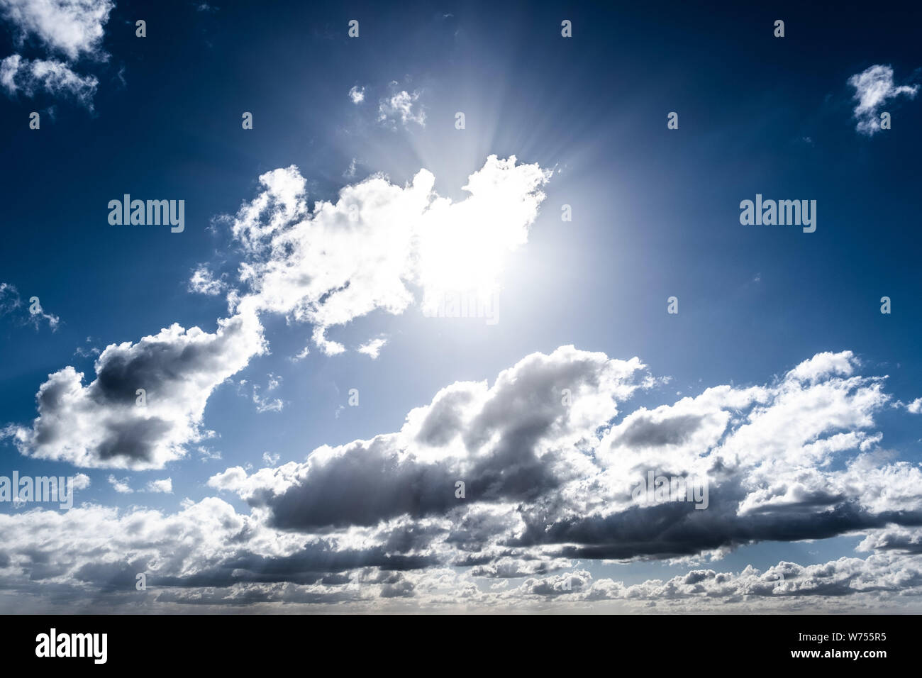 Sun shining through clouds background overlay Stock Photo - Alamy