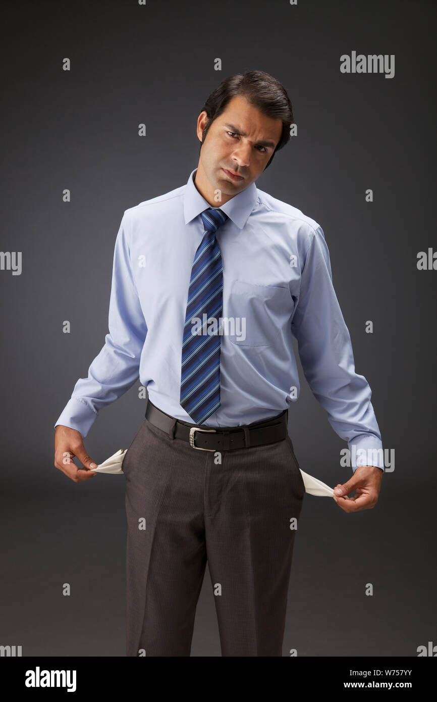 Businessman showing out his empty pockets Stock Photo - Alamy