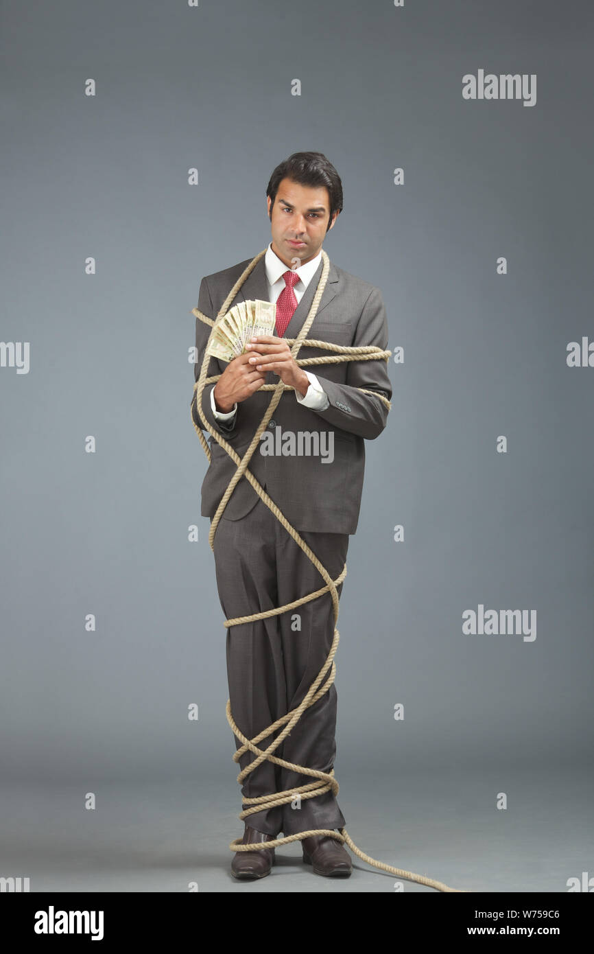 Businessman tied up rope hi-res stock photography and images - Alamy
