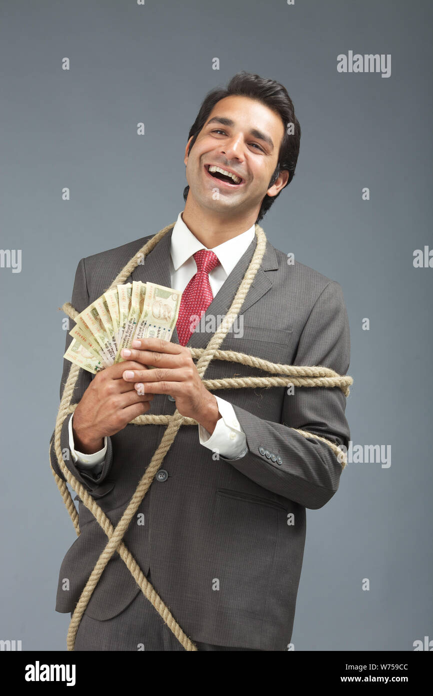 Businessman tied up rope hi-res stock photography and images - Alamy