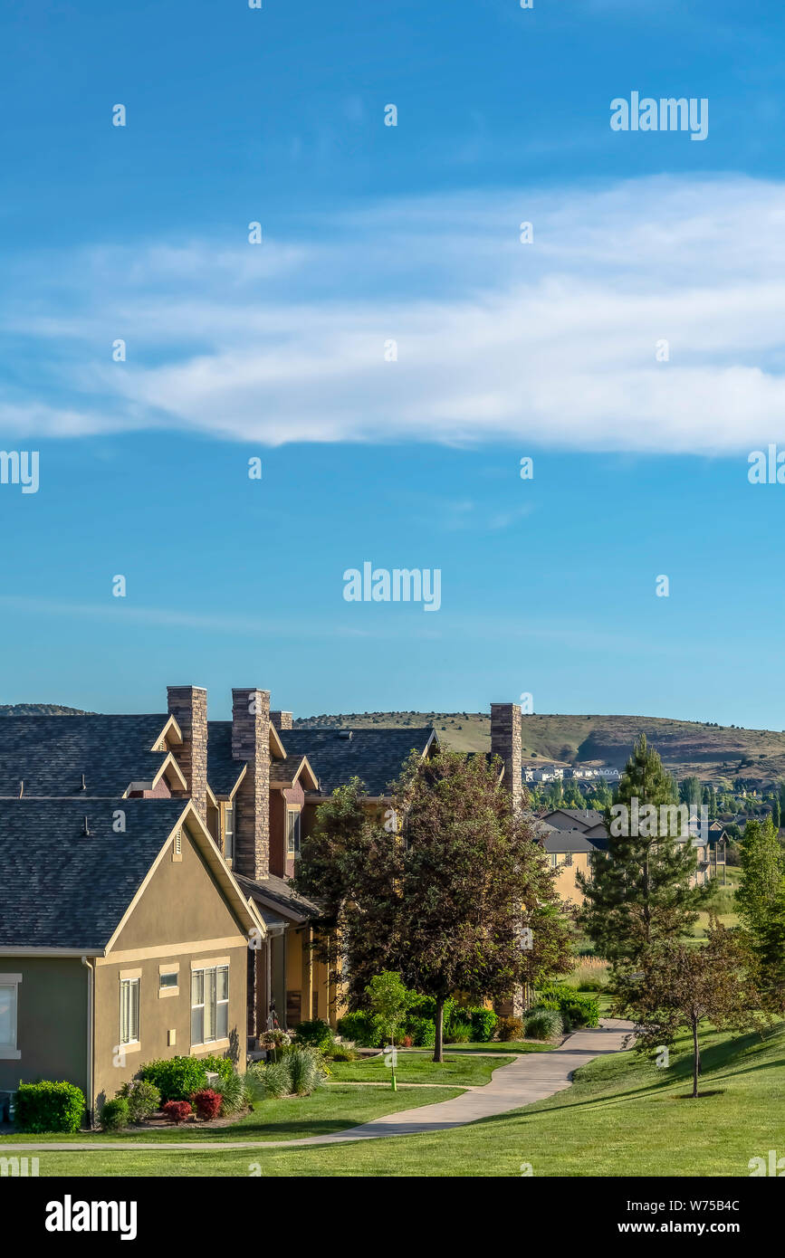 Beautiful houses on a neighborhood surrounded by trees and grassy ...