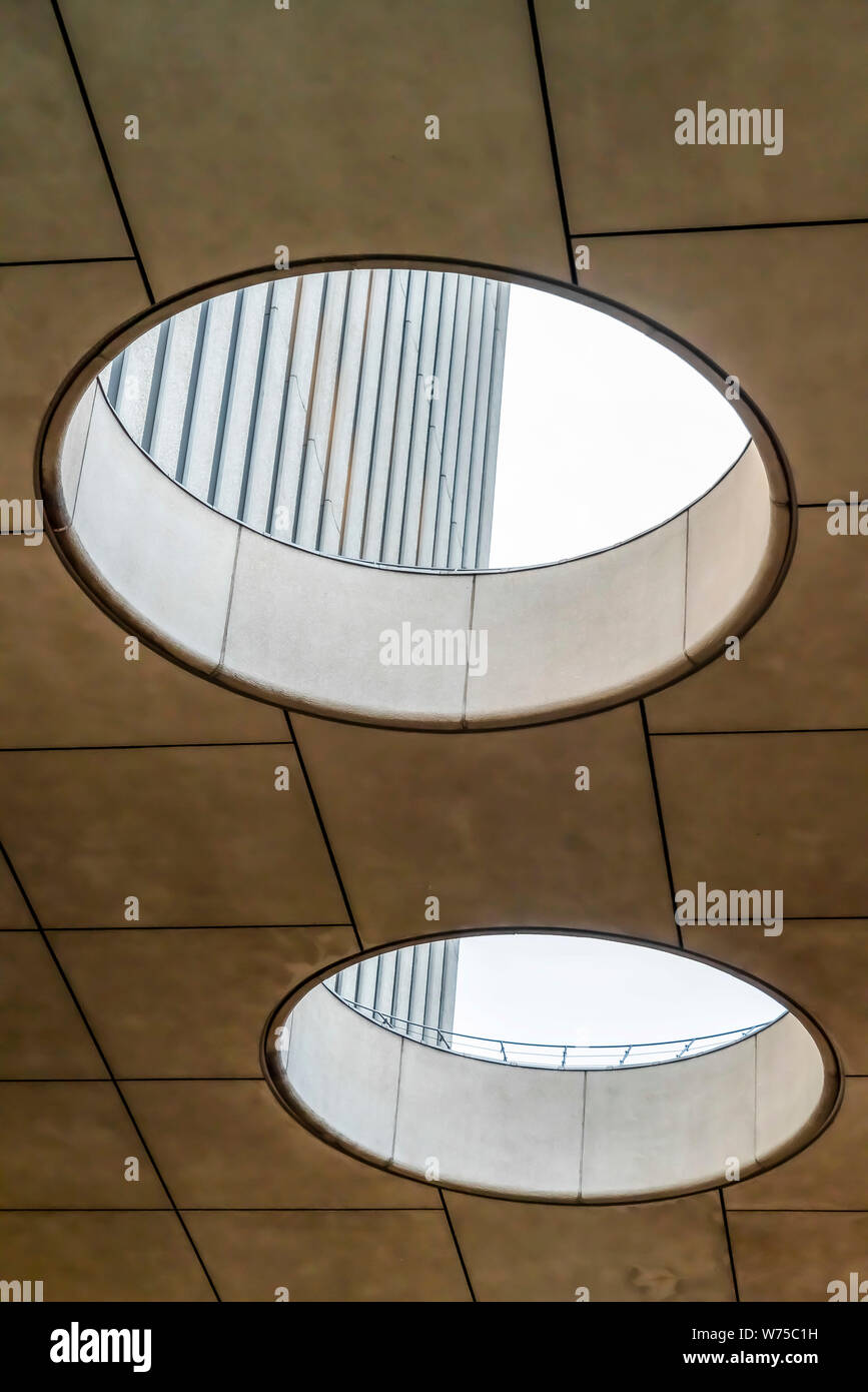 Circular skylights inside a building with view of the concrete exterior ...