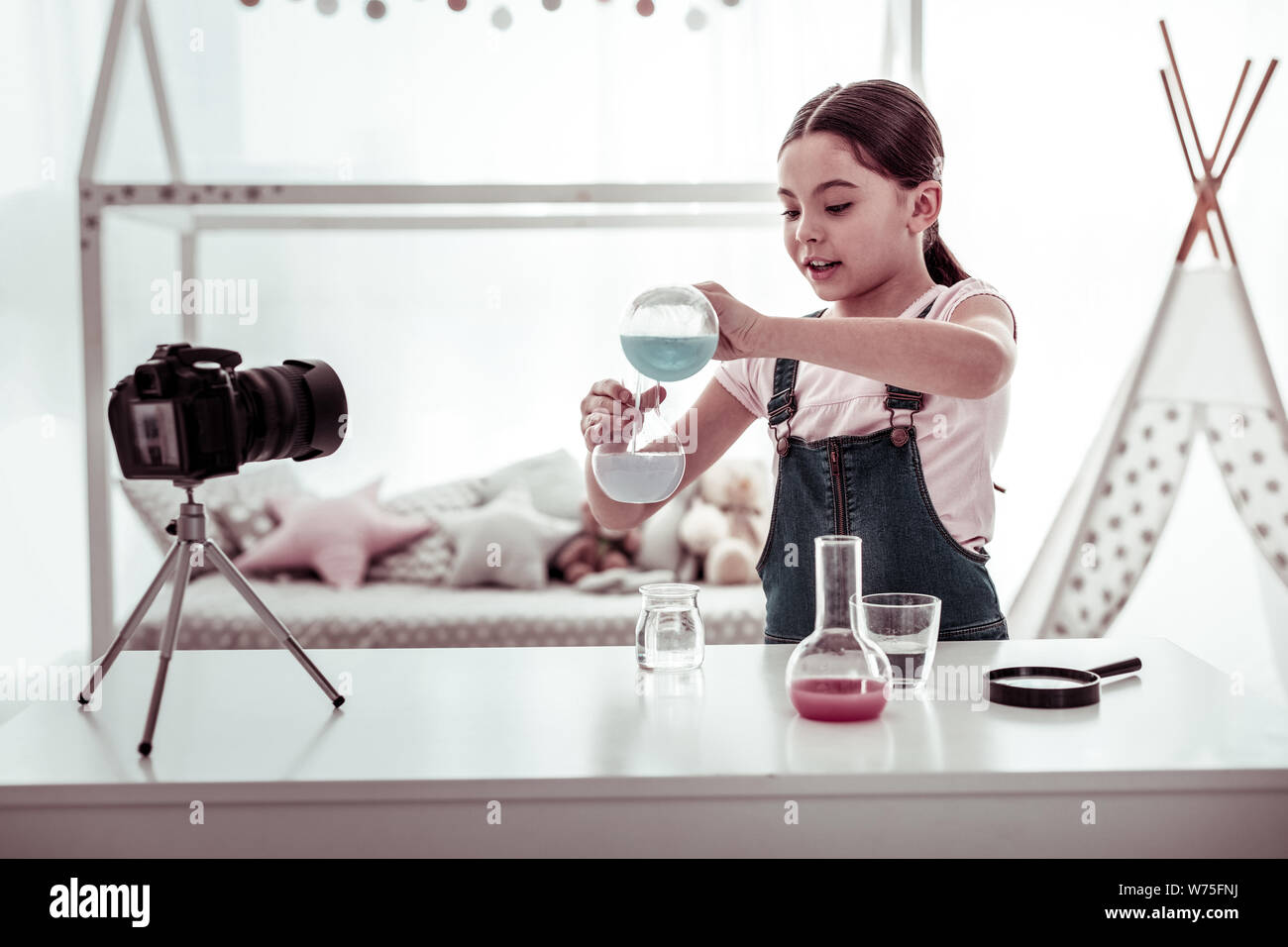Positive smart girl taking a video for her science blog Stock Photo - Alamy