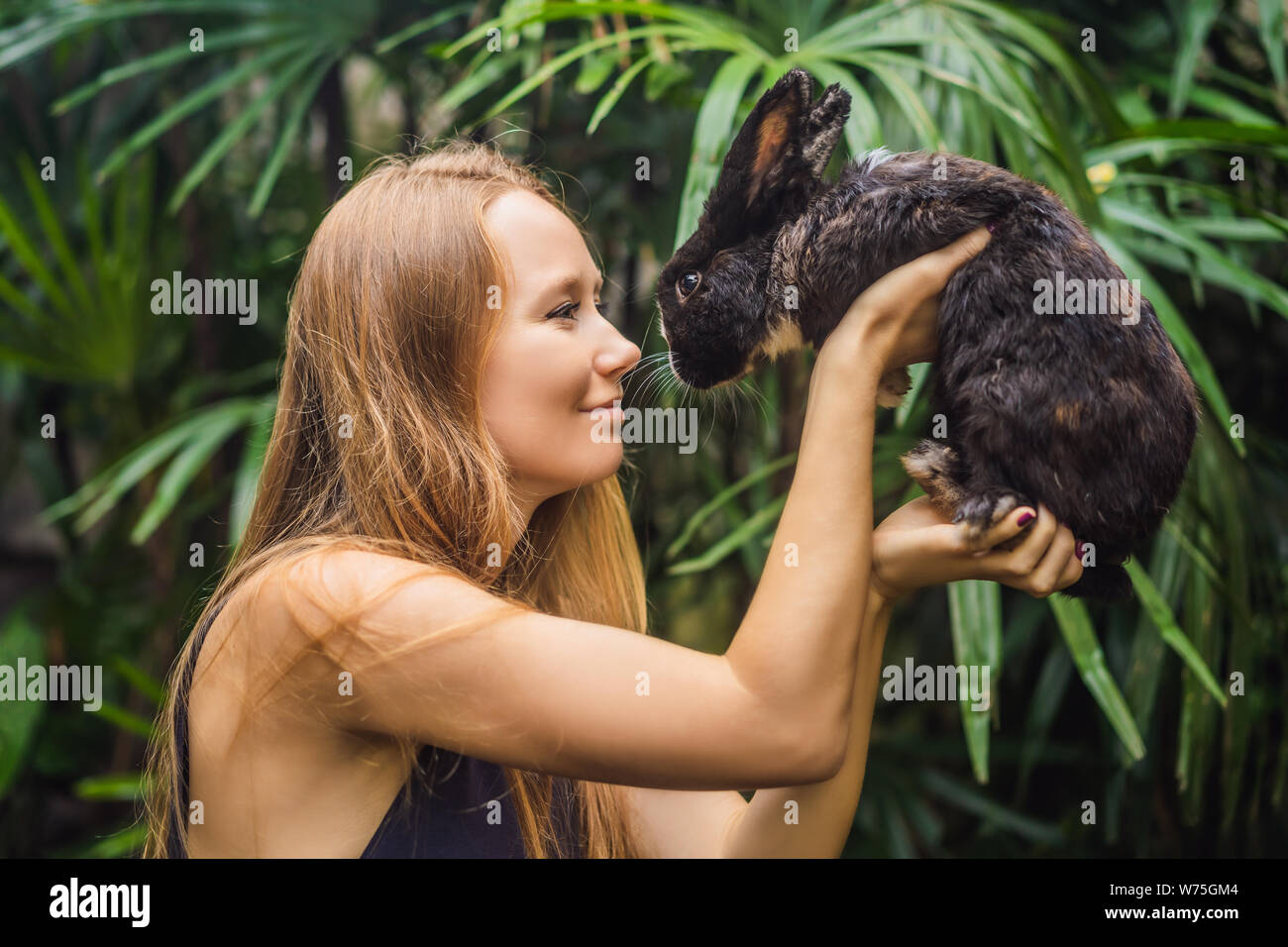 Woman holding a rabbit. Cosmetics test on rabbit animal. Cruelty free ...