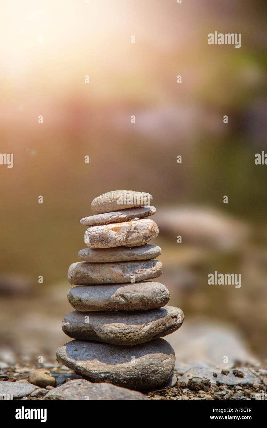 River stones Balanced on the Rock. Pyramid of river stones on of one ...