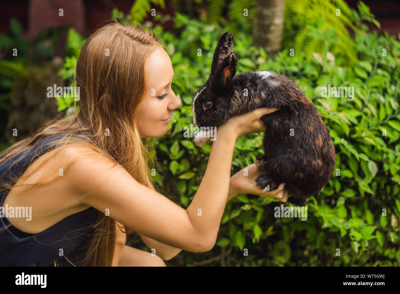 Woman holding a rabbit. Cosmetics test on rabbit animal. Cruelty free ...