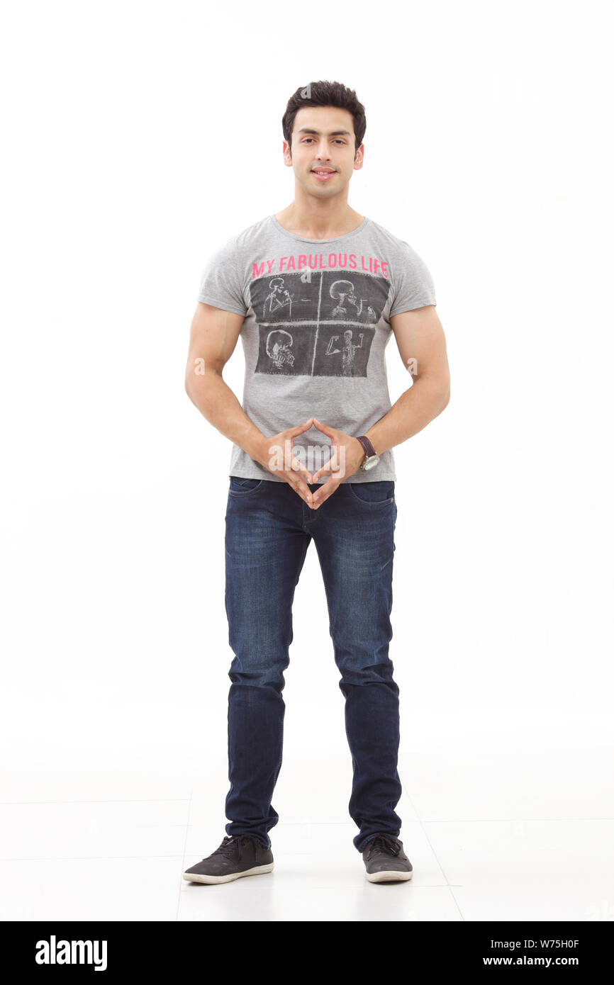 Young man standing Stock Photo - Alamy