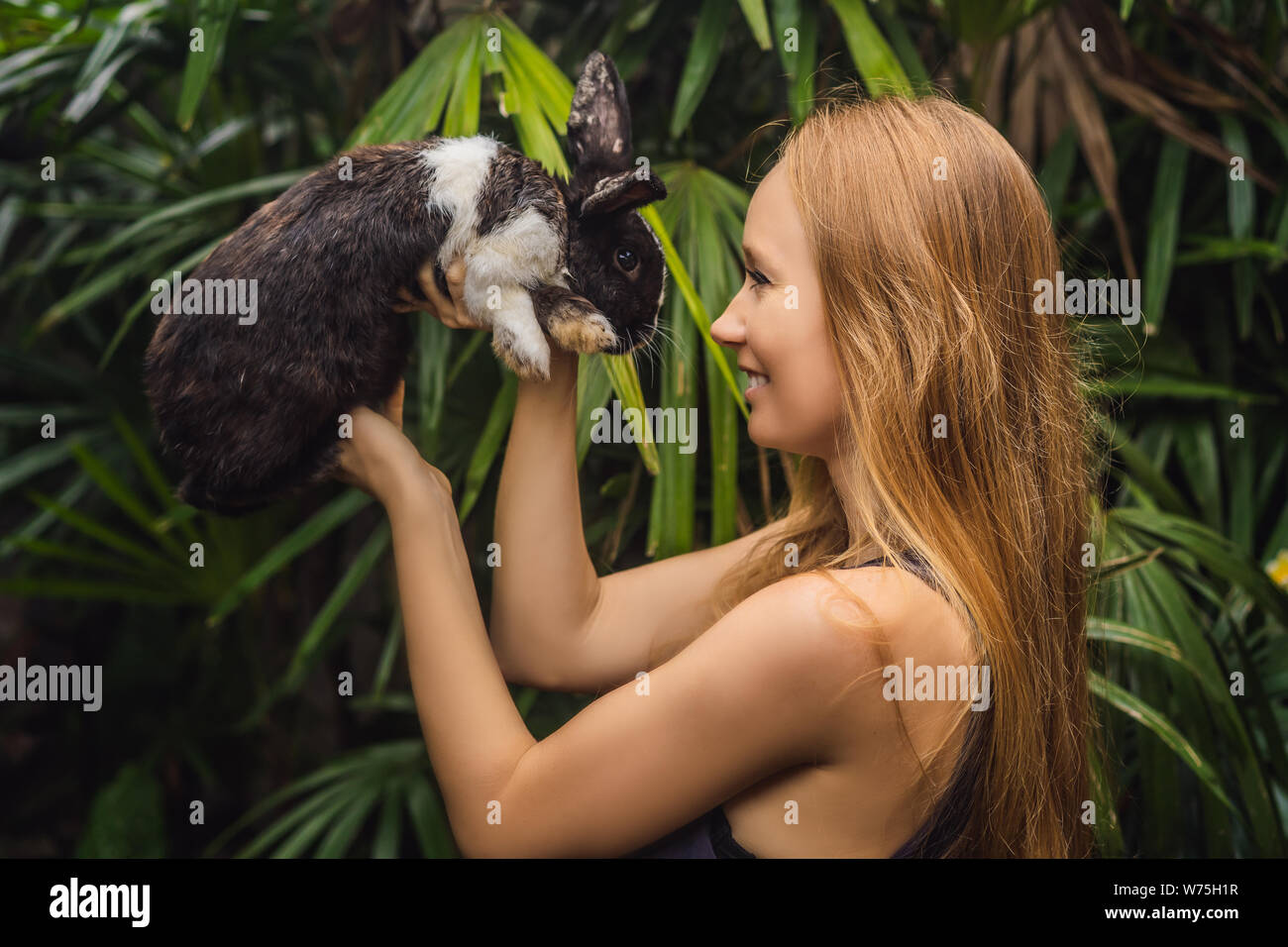 Woman holding a rabbit. Cosmetics test on rabbit animal. Cruelty free ...