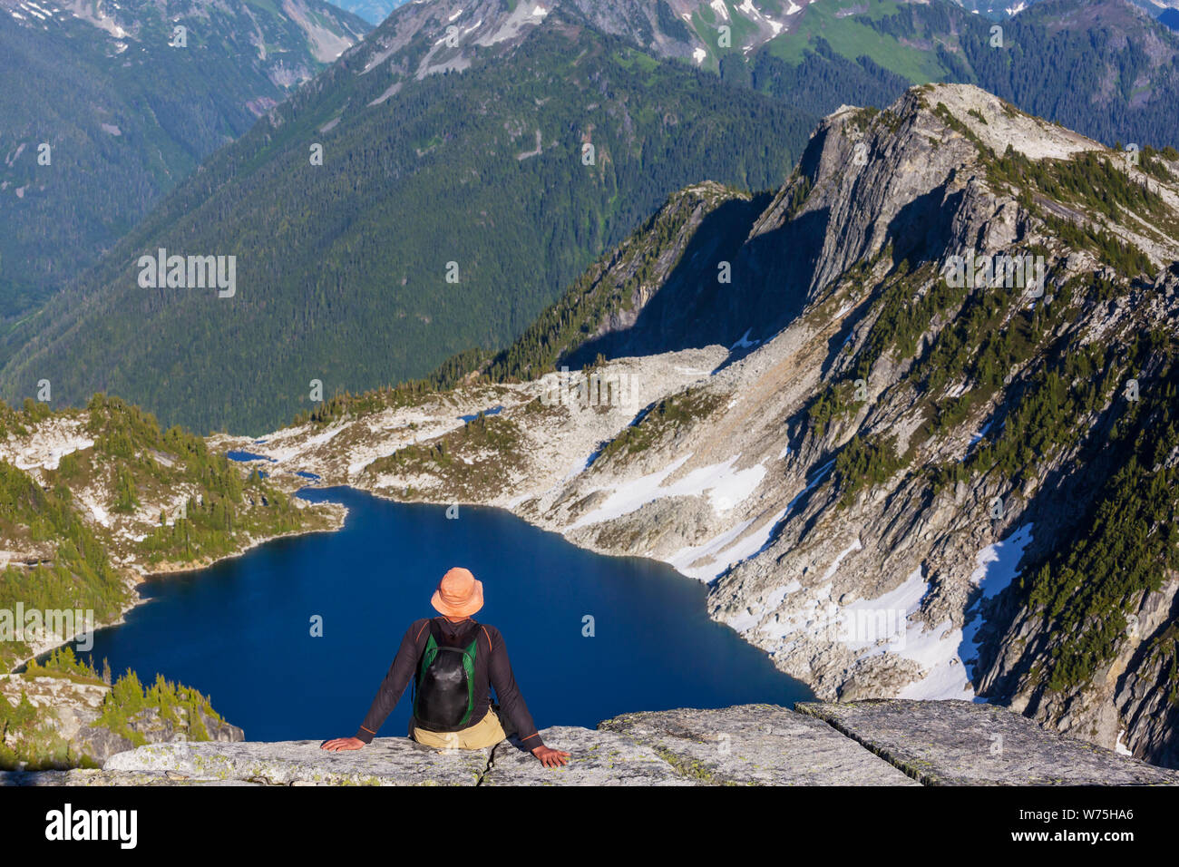 Backpacker in a hike in the summer mountains Stock Photo - Alamy