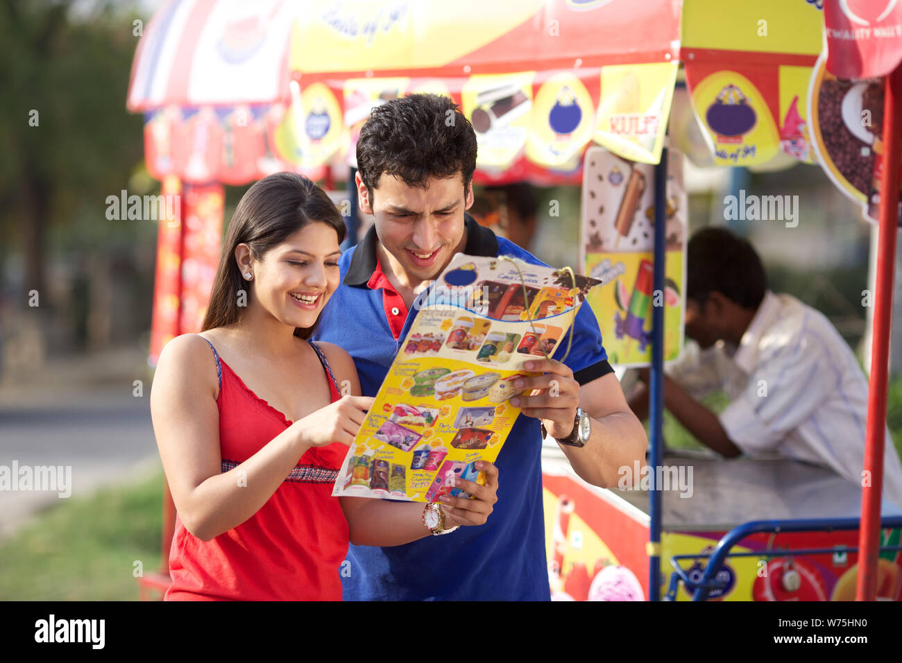 Young couple selecting ice cream for menu at ice cream stand Stock ...